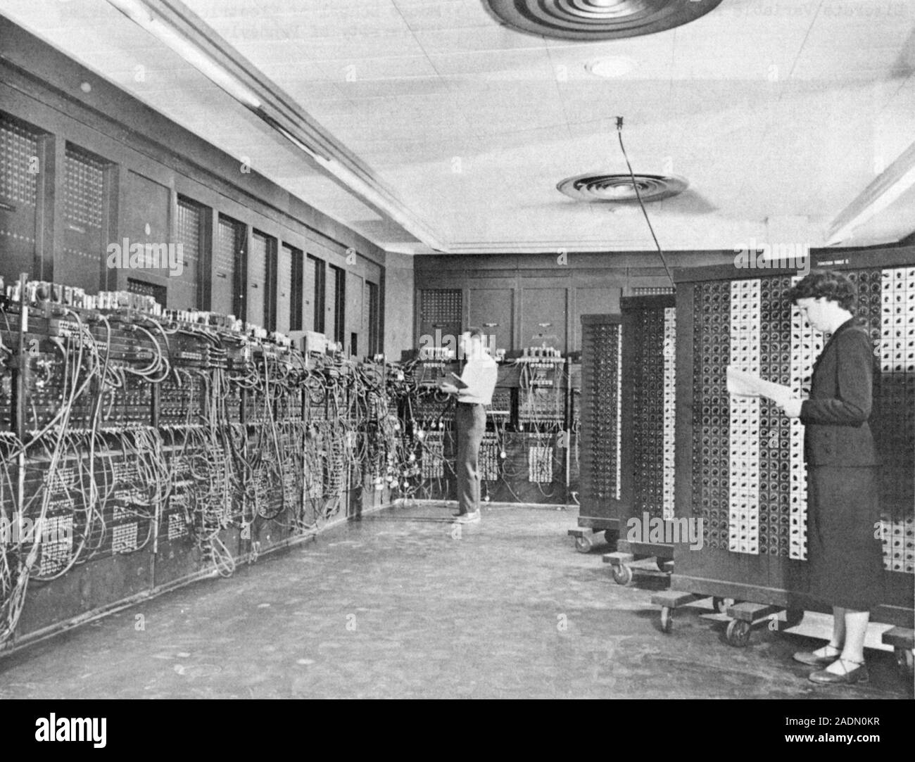 ENIAC digital calculator. Technicians working with the ENIAC device, a ...