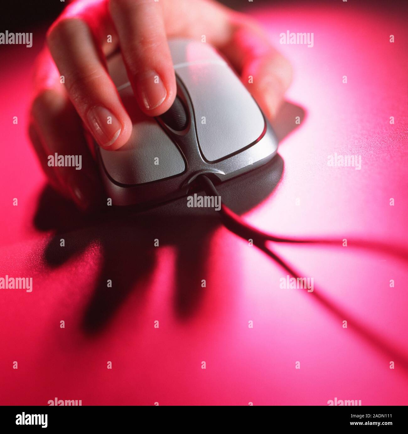 Computer mouse. Hand grasping a mouse for a personal computer (PC). The ...