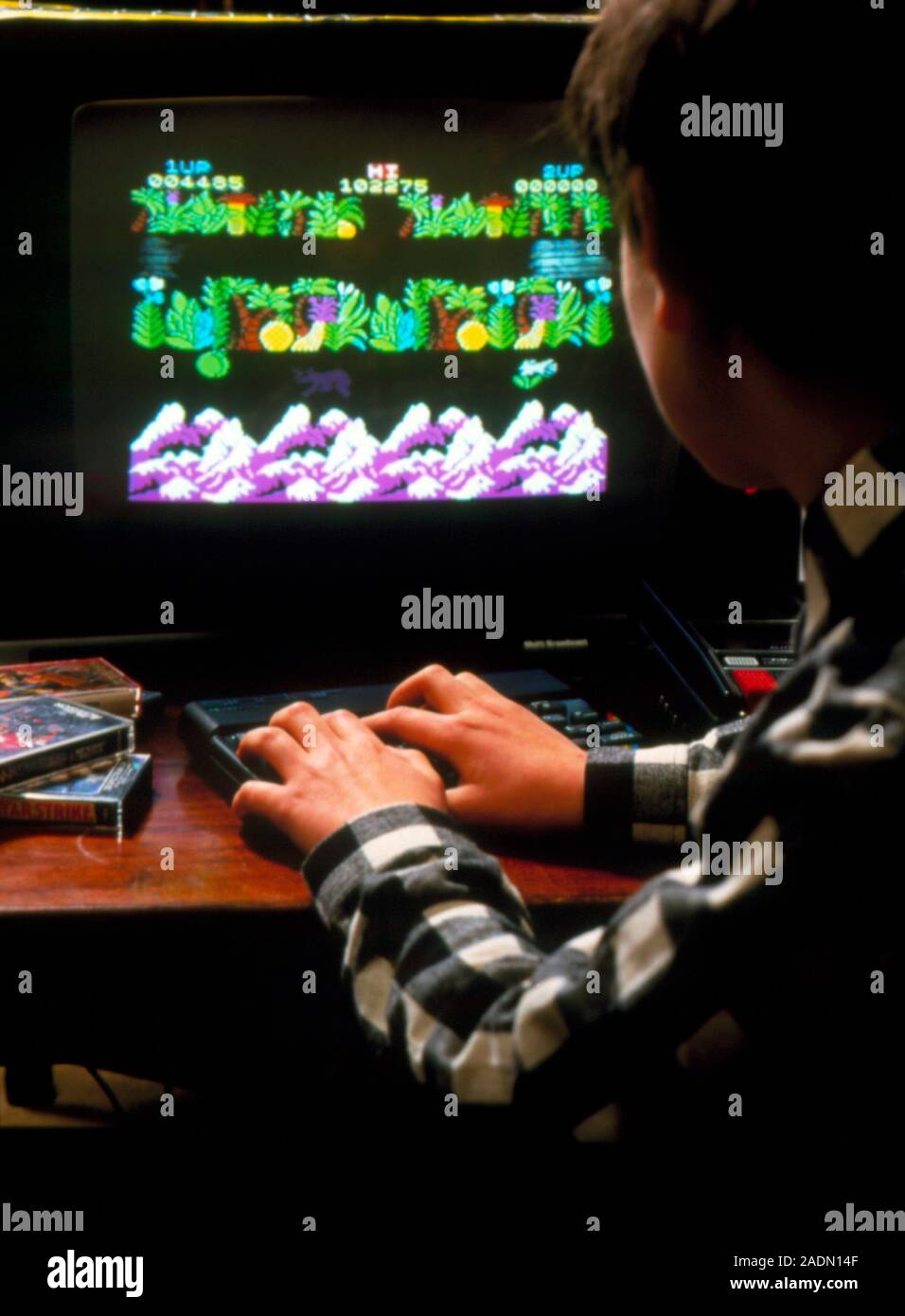 Boy playing video games using a Sinclair ZX Spectrum micro computer ...