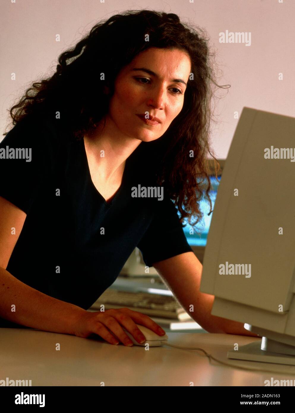Home computer. View of a woman operating a personal computer (PC) at ...