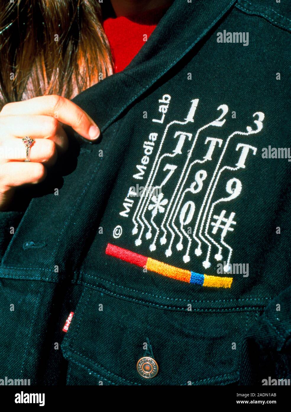 Mobile phone jacket. Researcher wearing a digital mobile phone denim ...