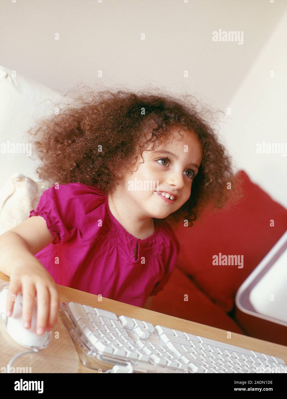 MODEL RELEASED. Computer use. Three year old girl using a computer ...