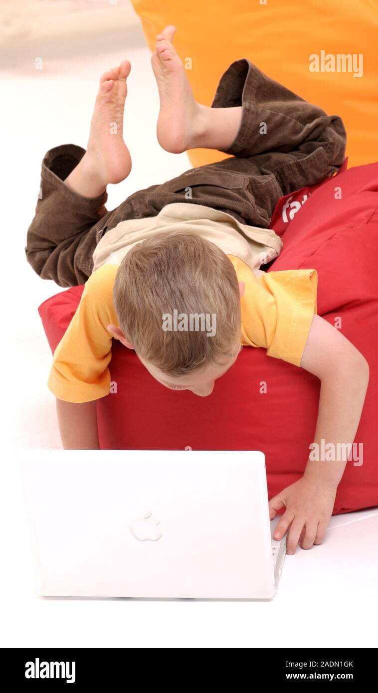 Boy using a laptop computer Stock Photo - Alamy