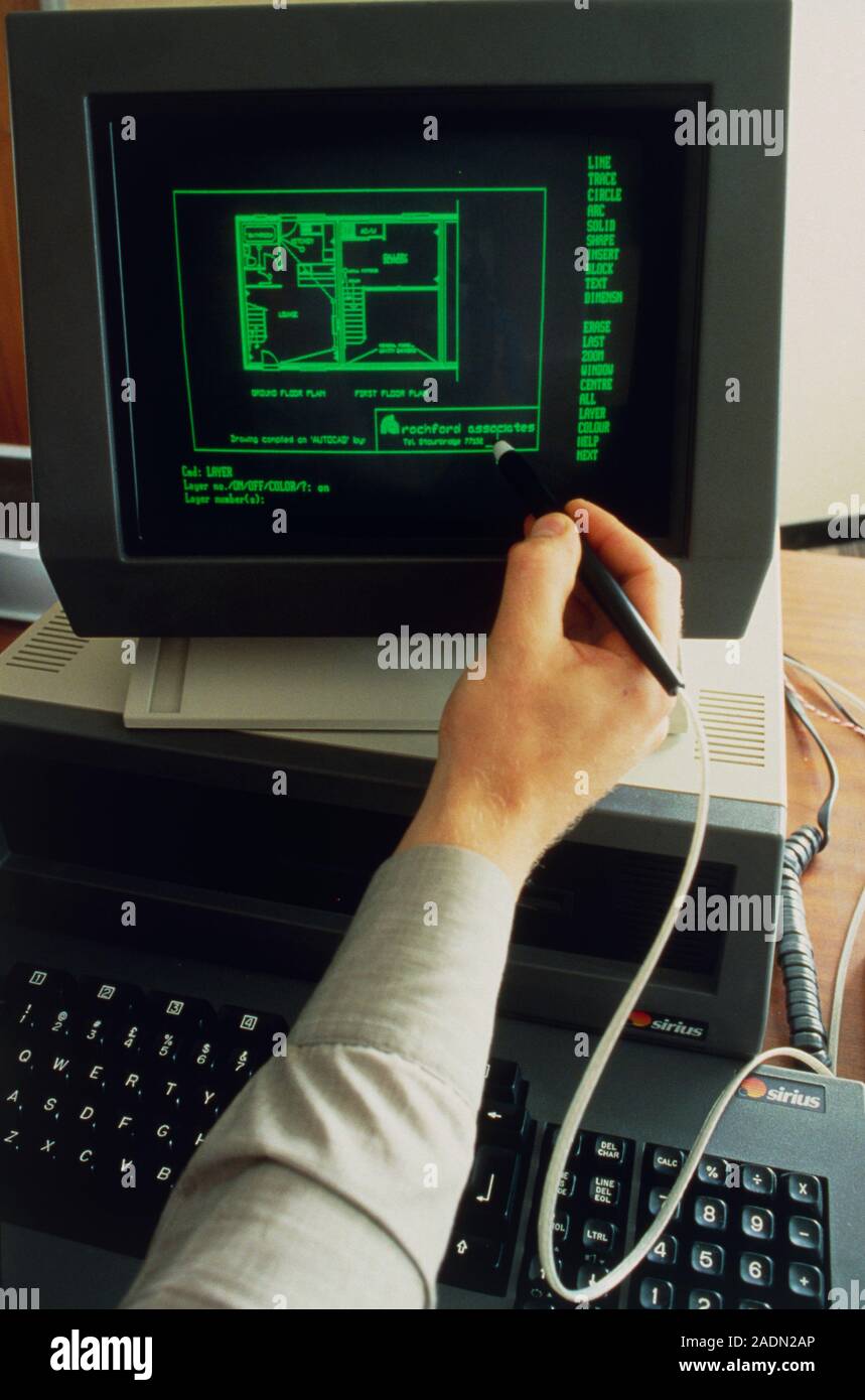 Operator using light pen to select from the menu display on the screen ...