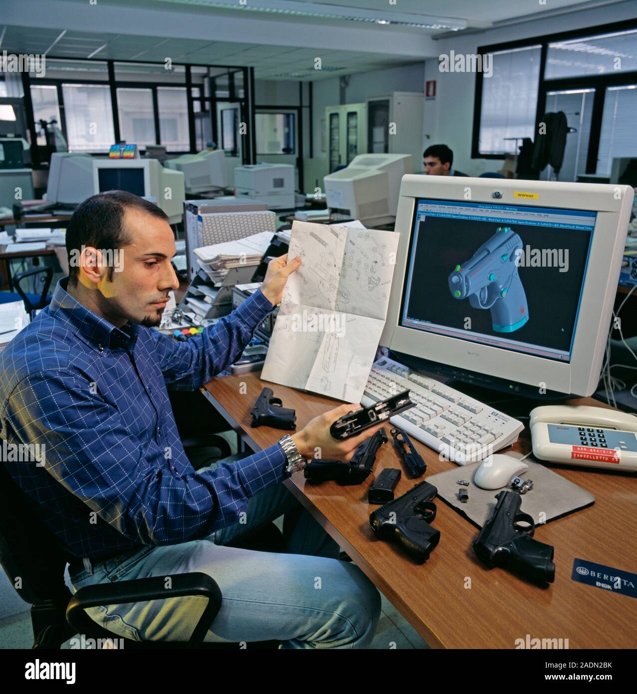 Computer-aided gun design. Beretta gun designer using a computer-aided ...
