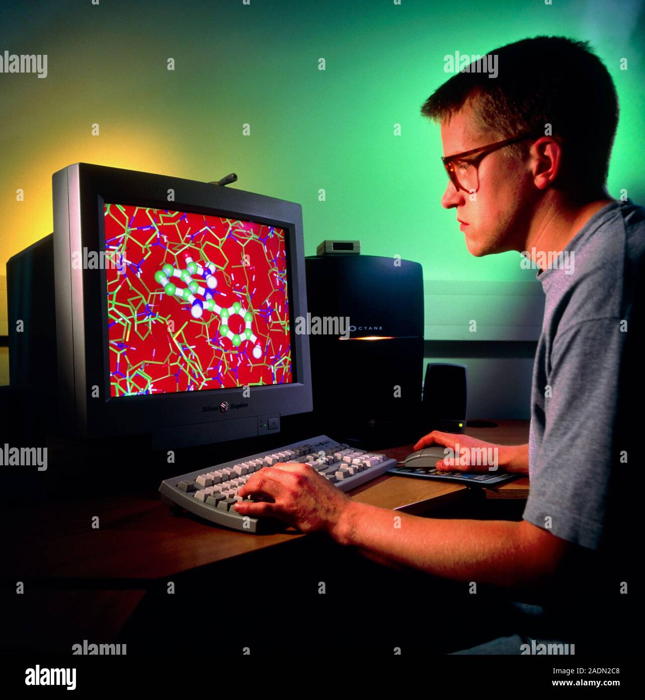 Anticancer drug design. Researcher using a computer to model the ...