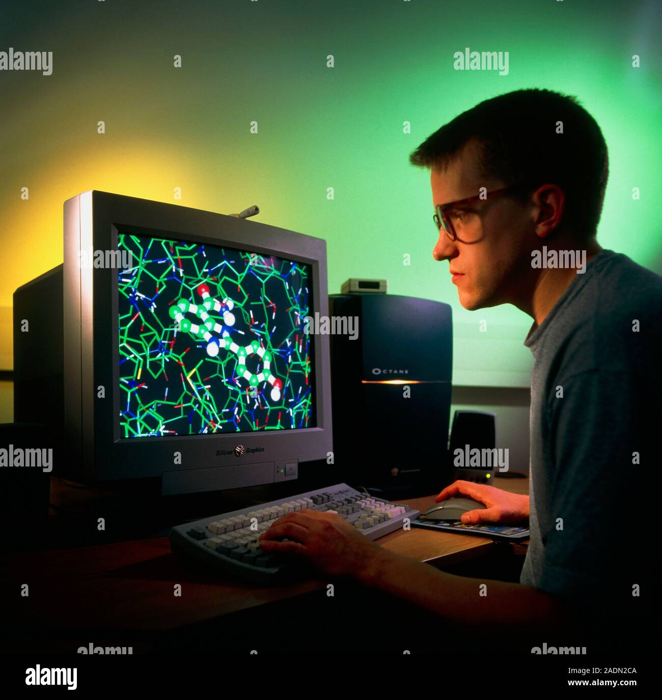 Anticancer drug design. Researcher using a computer to model the ...