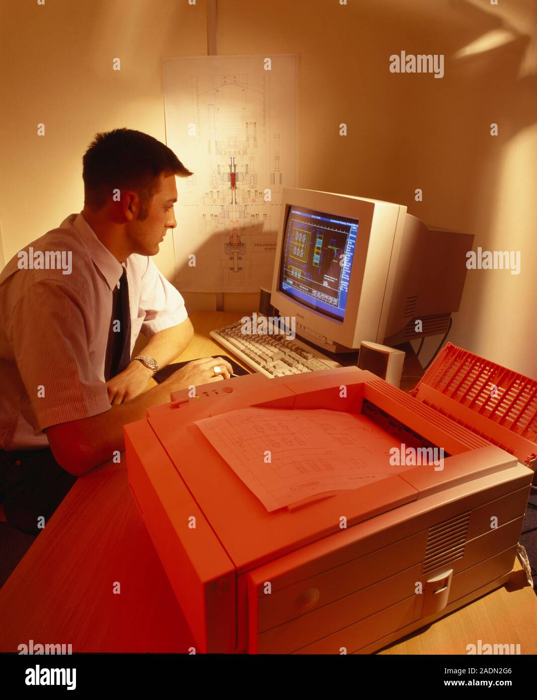 Computer-aided engine design. Man using a CAD/CAM (computer-aided ...