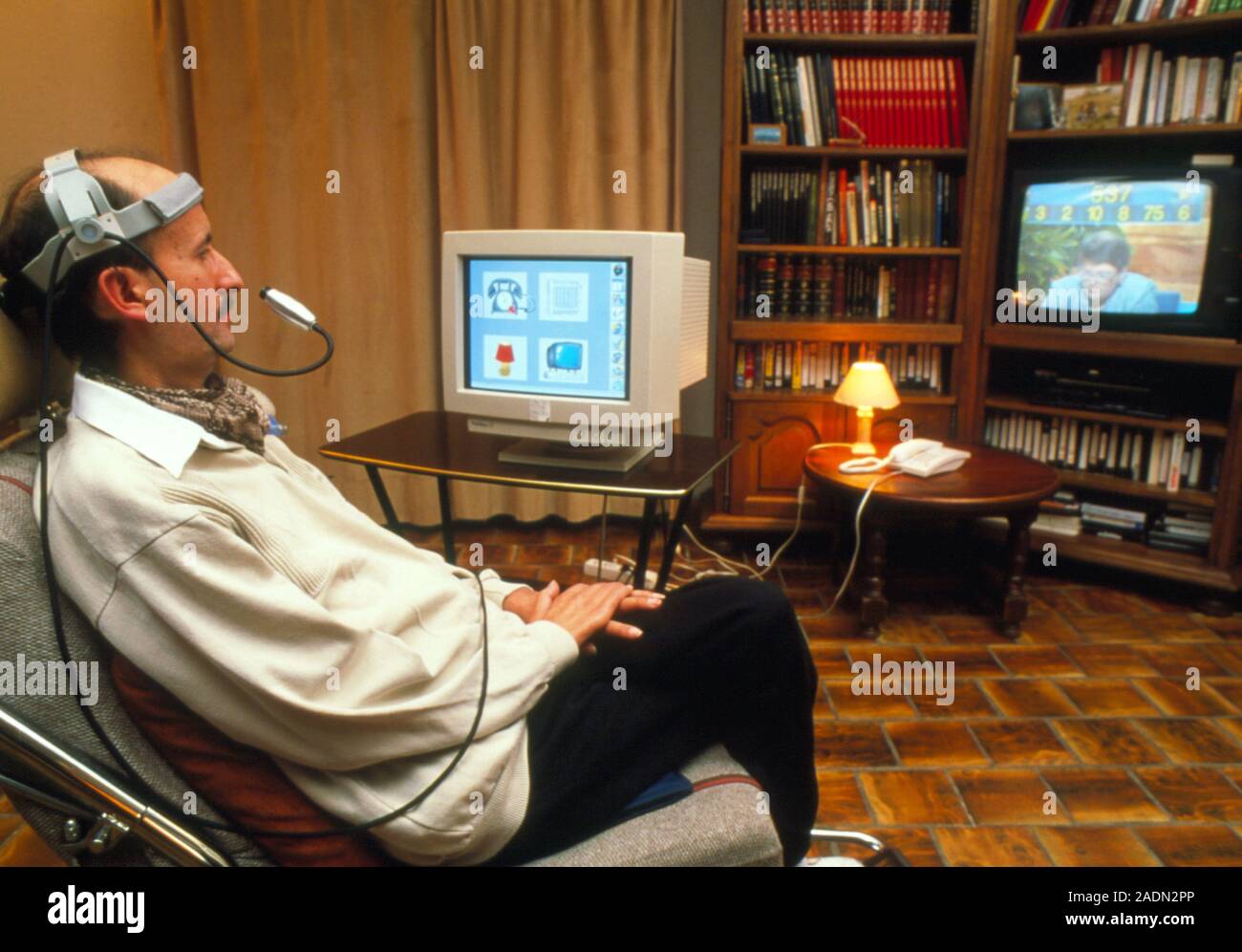 Interactive computer. Disabled man using the eye access interactive ...