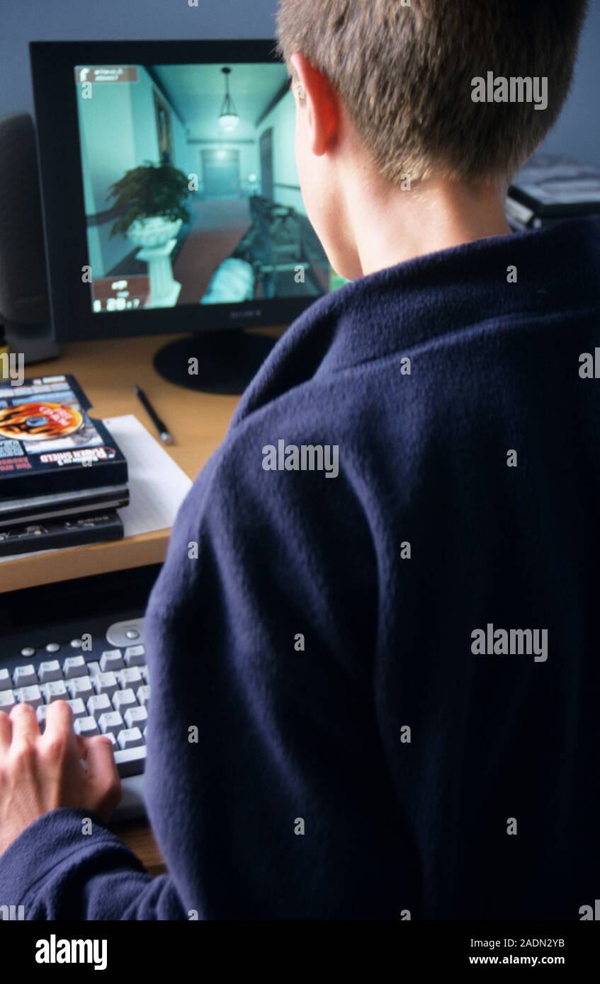 Computer game. Boy playing a virtual reality computer game on a ...