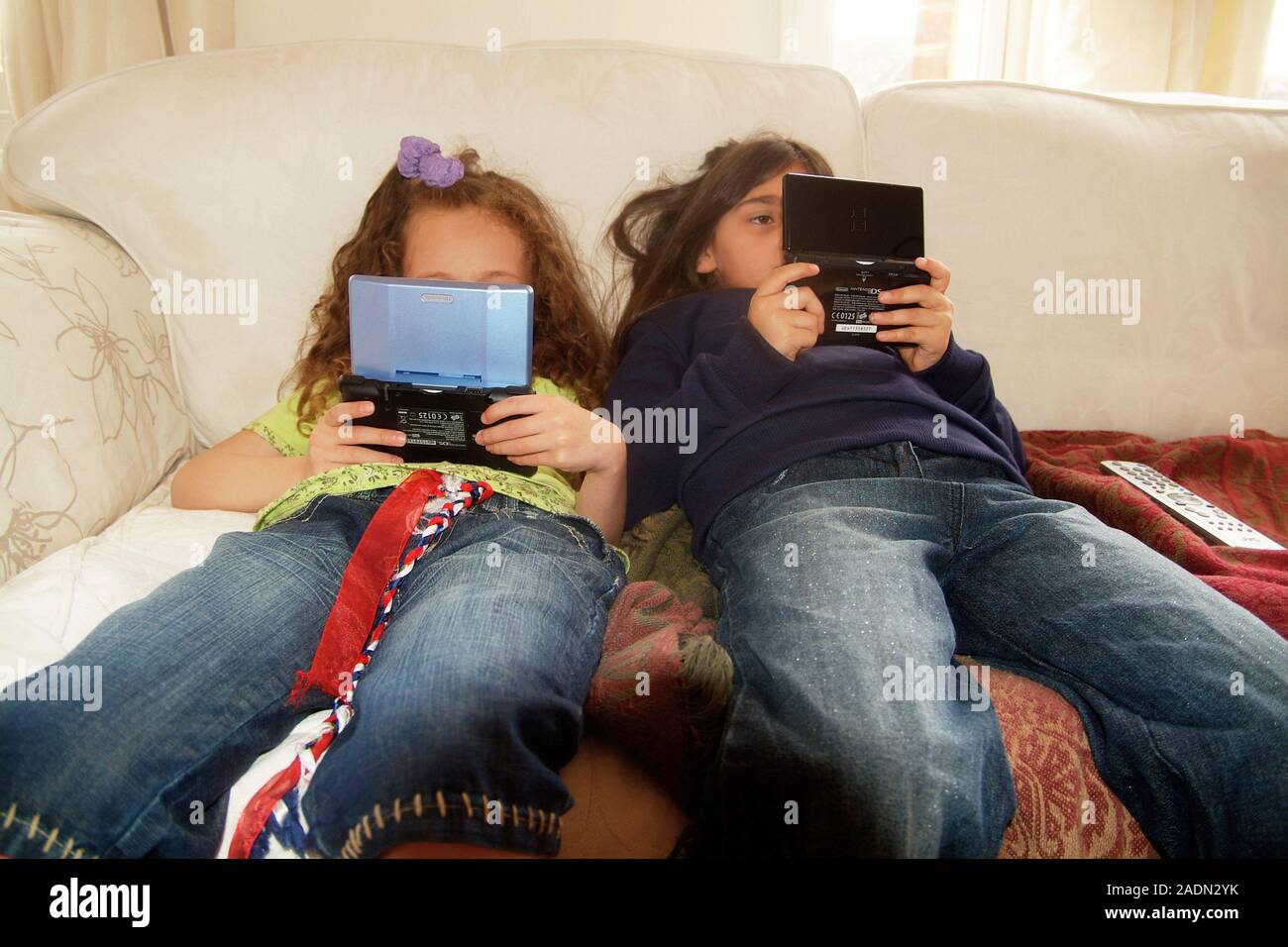 MODEL RELEASED. Personal computer games. Young girls playing on hand ...
