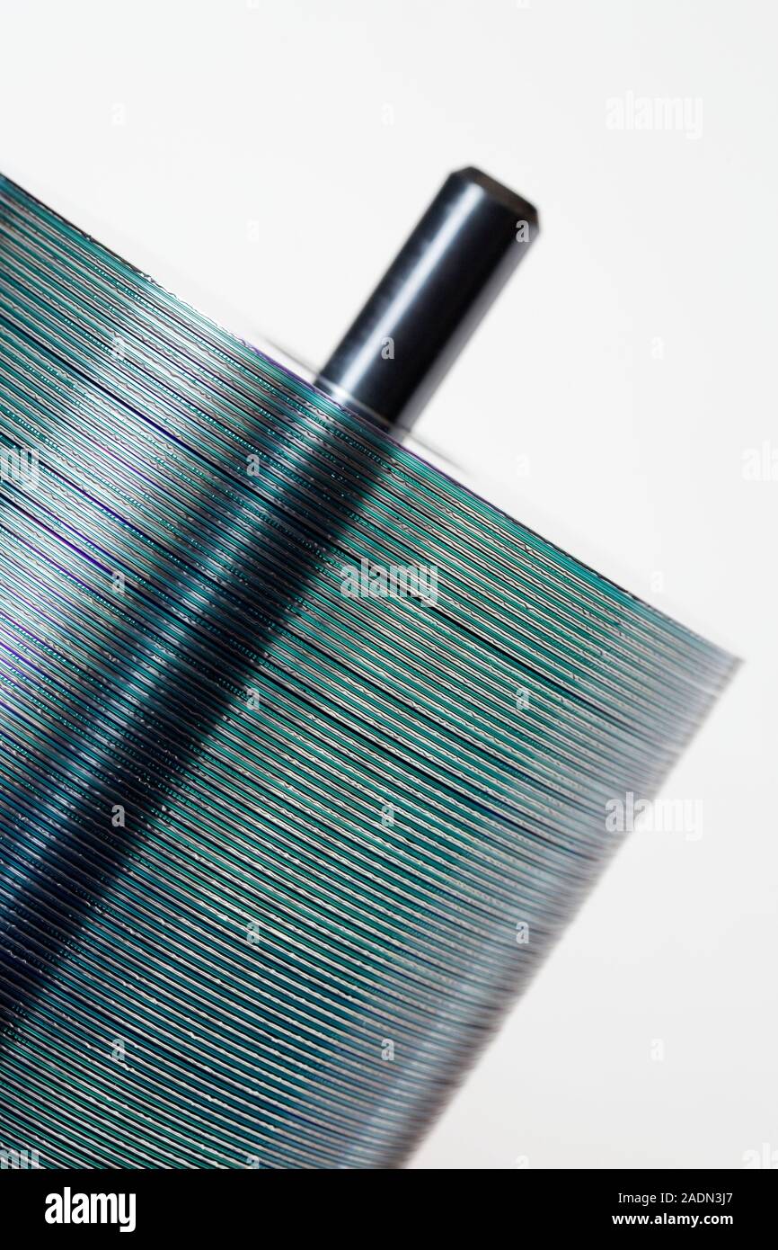 Digital versatile discs (DVDs) stored on a spindle. These optical discs ...