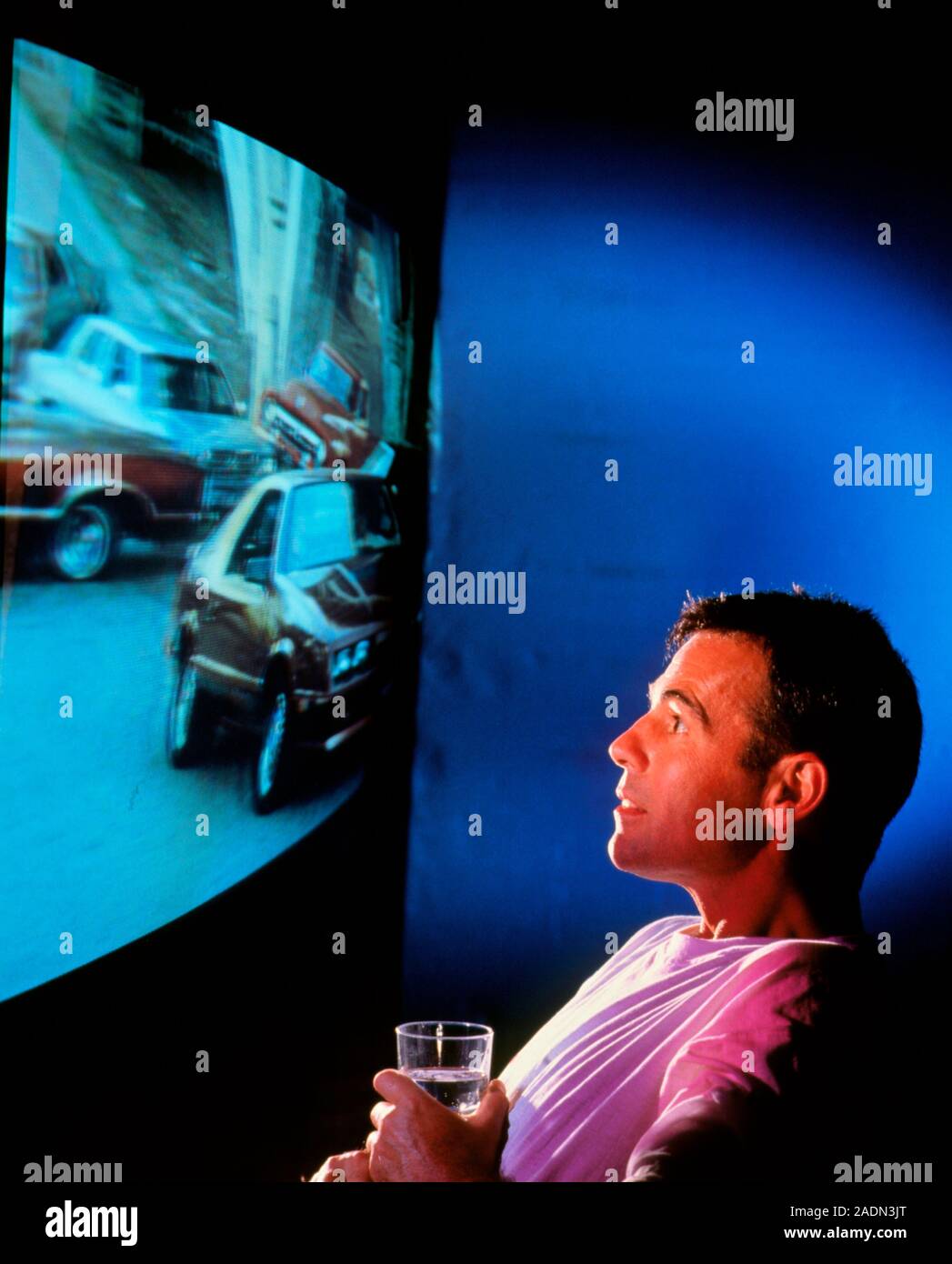 Television entertainment. Man at home watches violence on television ...