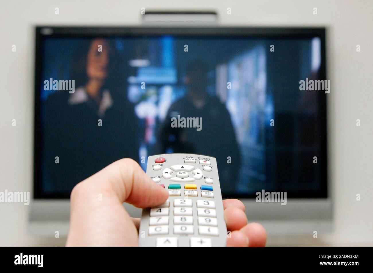 Using a television remote control Stock Photo - Alamy