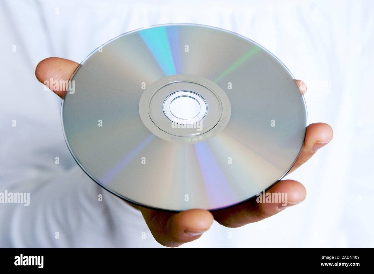 Compact disc (CD) being held in a hand. This is the correct way to hold ...