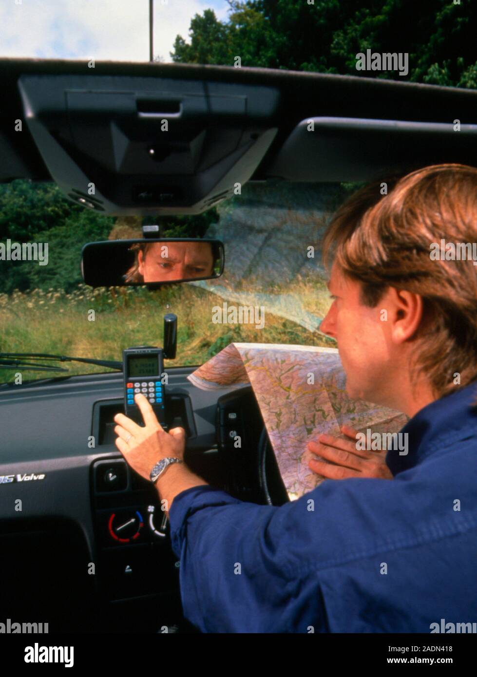 MODEL RELEASED: Satellite navigation. A car driver checking his ...