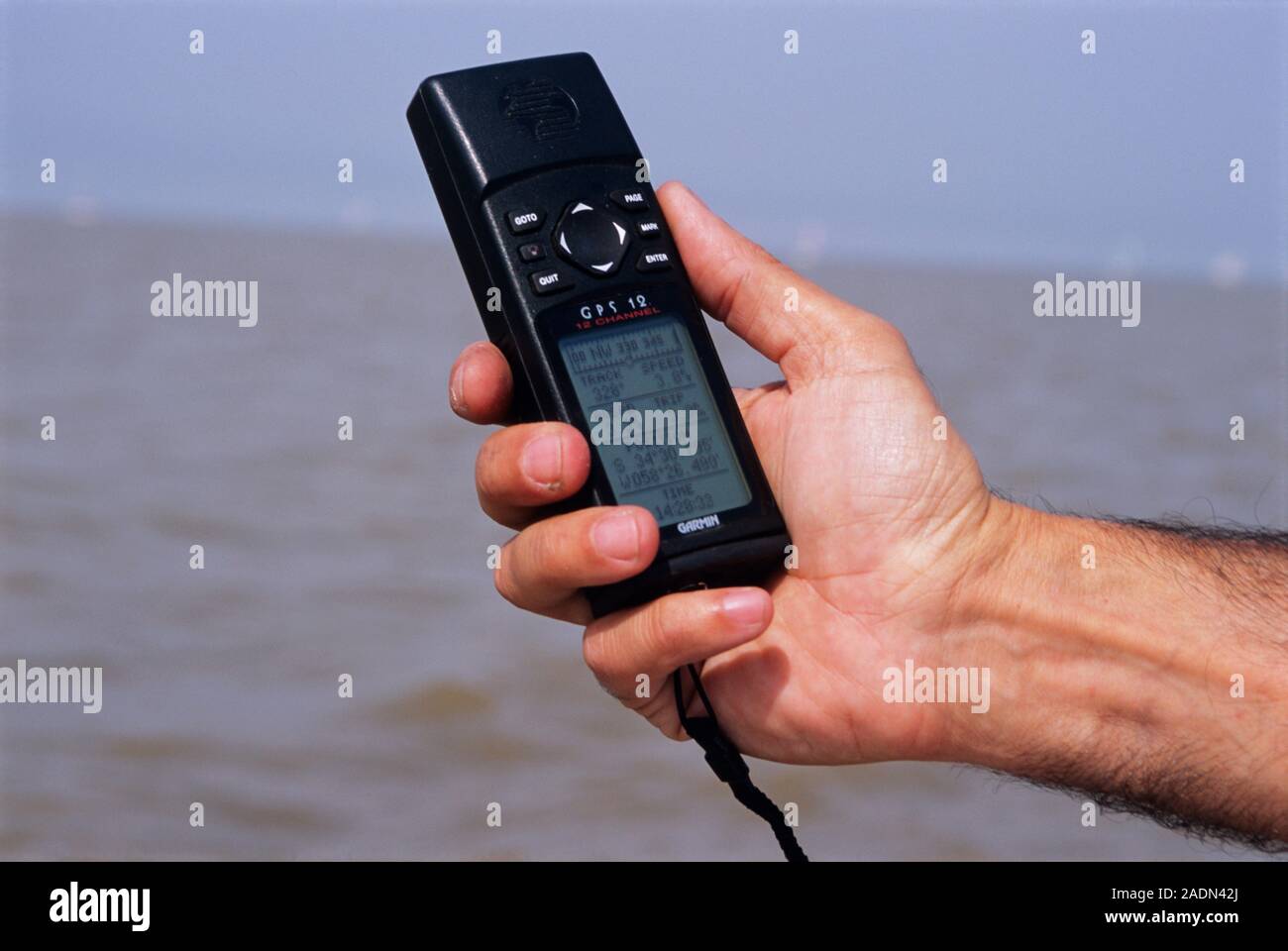 Global positioning system (GPS) receiver being held in a hand. The ...