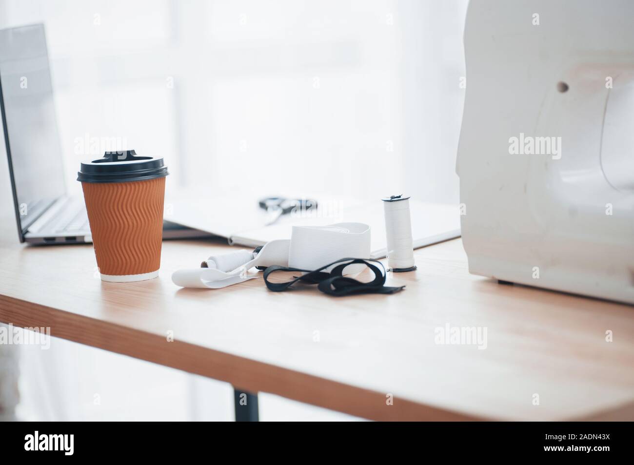 Close up photo of workspace with table and tools for sewing clothes on ...