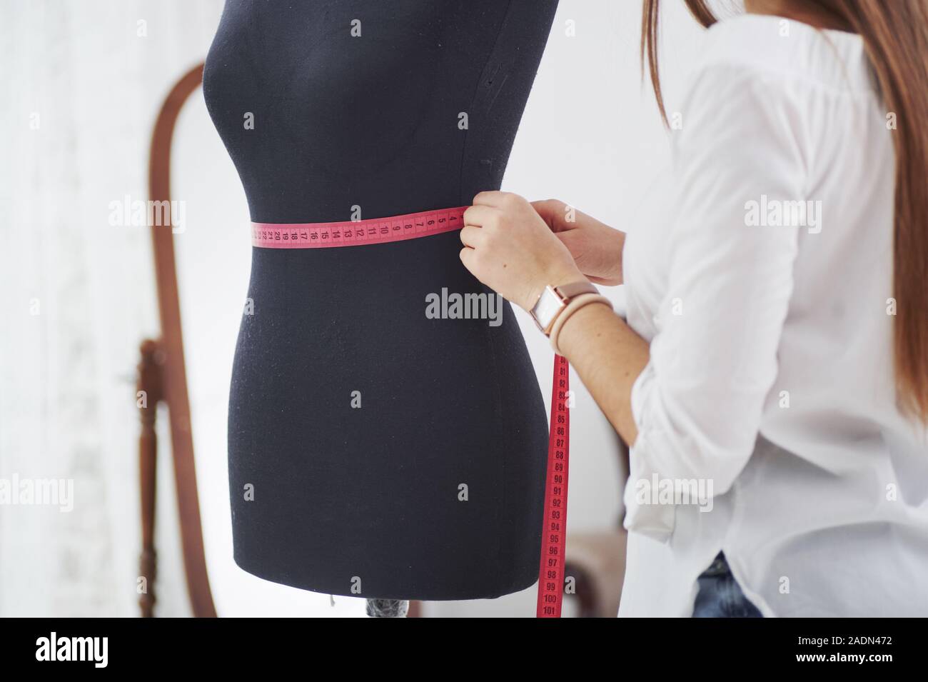 Waist of the mannequin. The process of fitting the dress in the studio ...