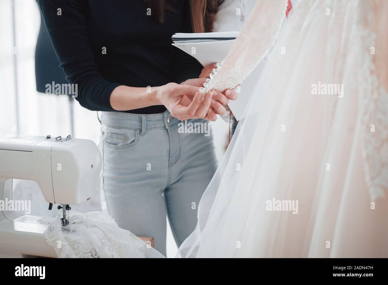 Work in progress. The process of fitting the dress in the studio of ...