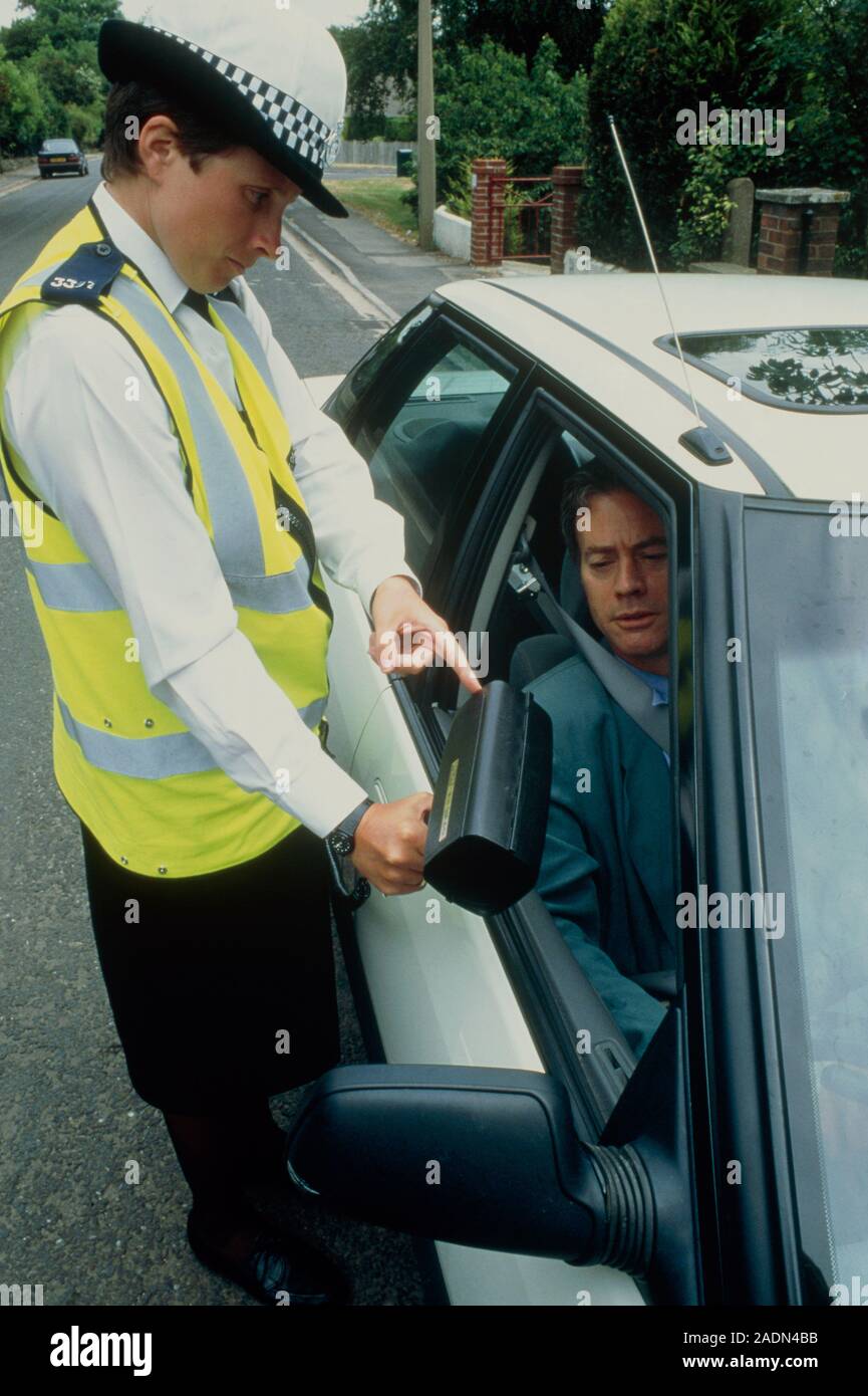 Radar speed gun. A policewoman shows the speed display on a radar speed ...
