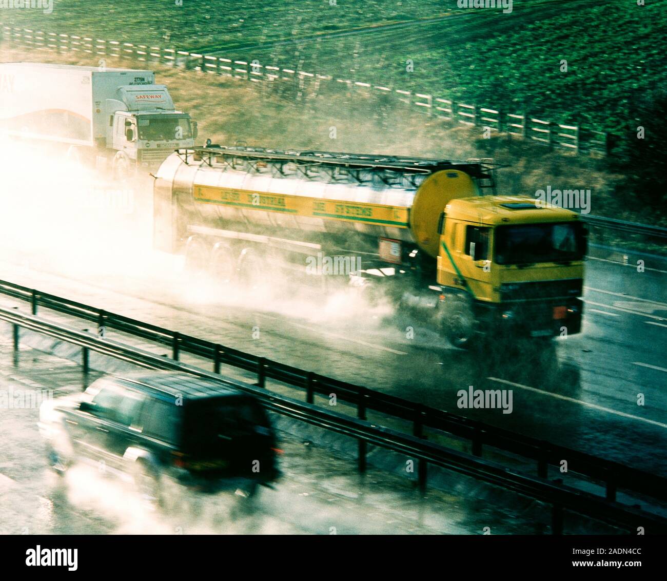 Traffic on wet motorway. Vehicles driving on a wet motorway after a ...