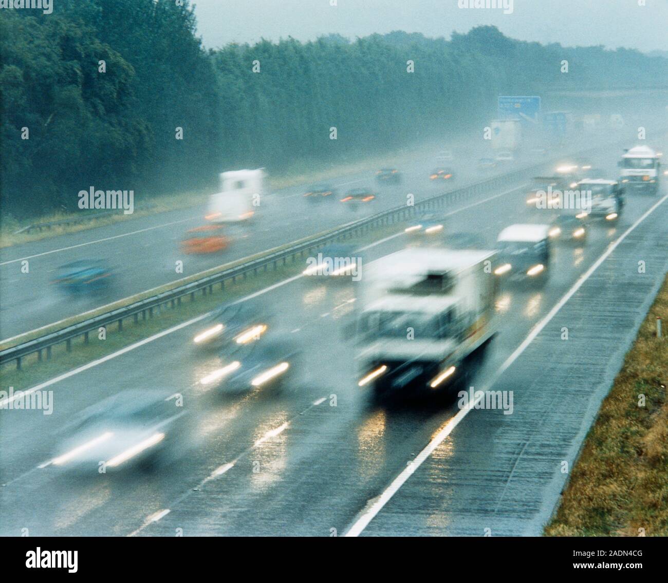 Motorway traffic in the rain. Time-exposure image of vehicles on the M3 ...