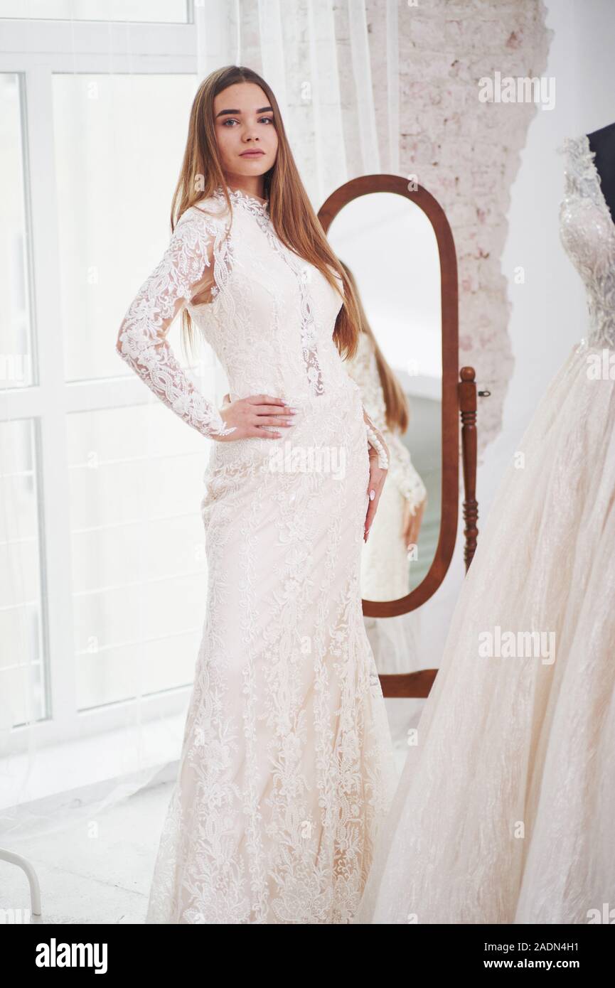 Bride poses for the camera. The process of fitting the dress in the ...