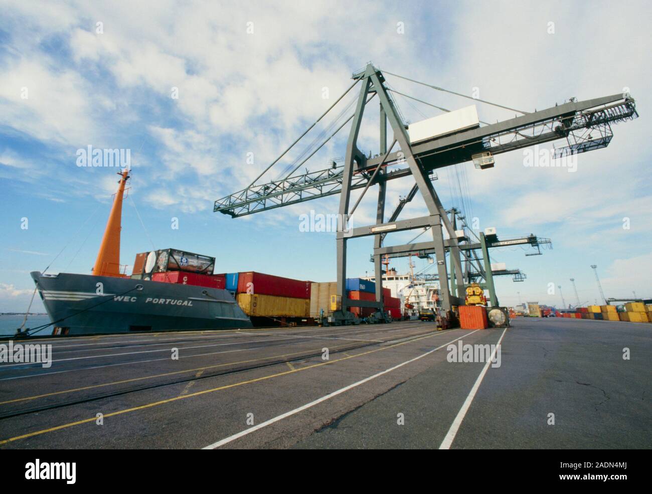 Container terminal. Ship and dockside cranes at a container port. The ...