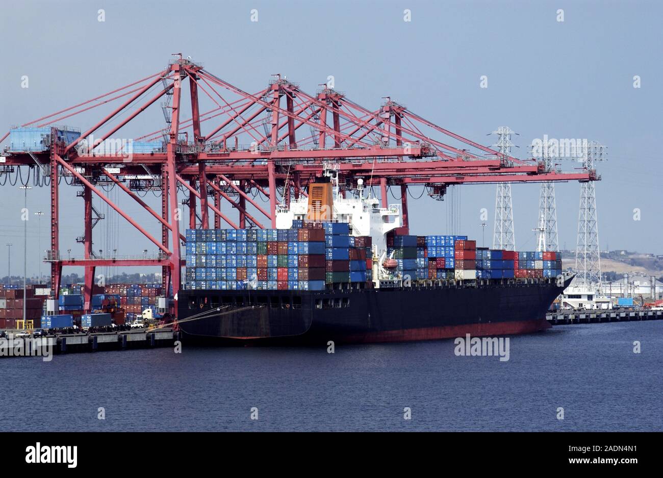 Container ship and dockside cranes. The containers are the large ...