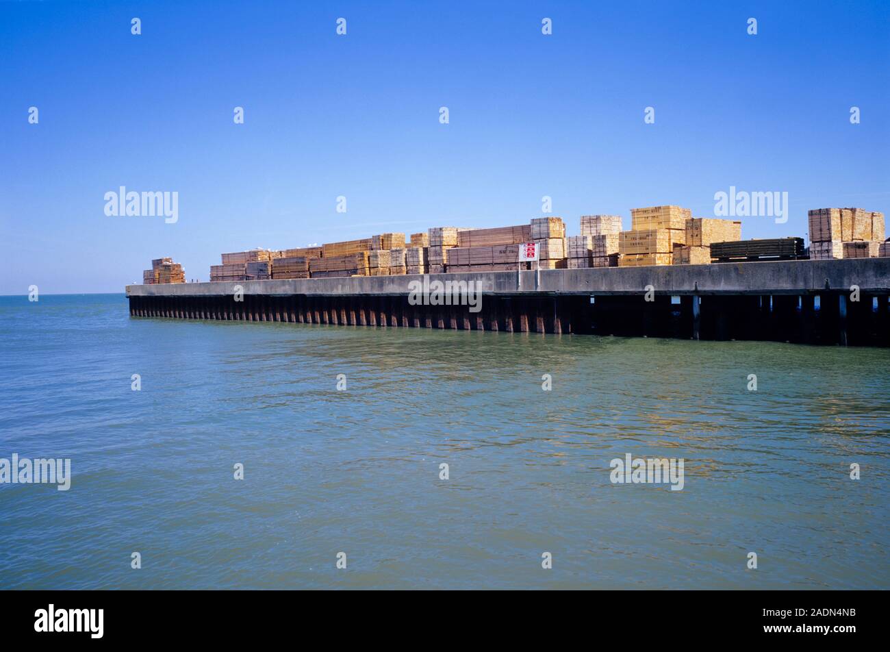 Wood cargo on a pier, ready for loading on to a ship or on to lorries ...