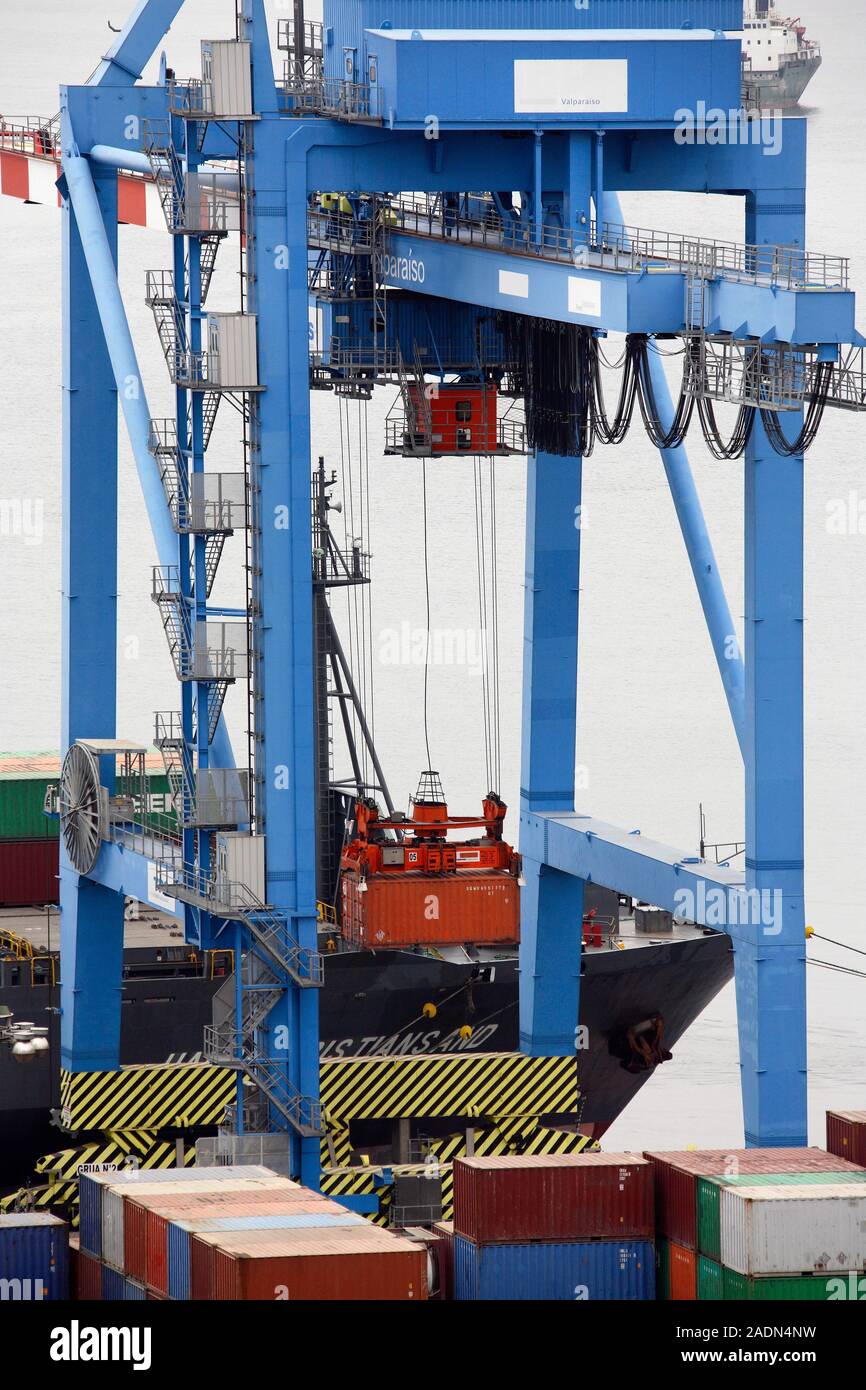 Container crane handling cargo. Containers being loaded aboard a ...