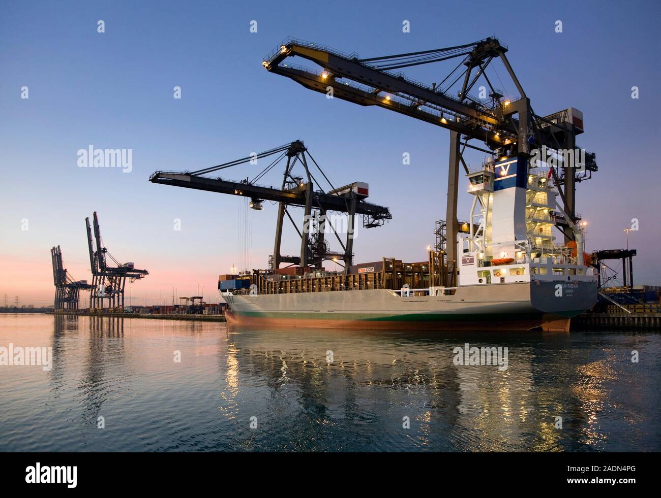 Container ship Jan-Fabian being loaded with cargo by dockside cranes ...