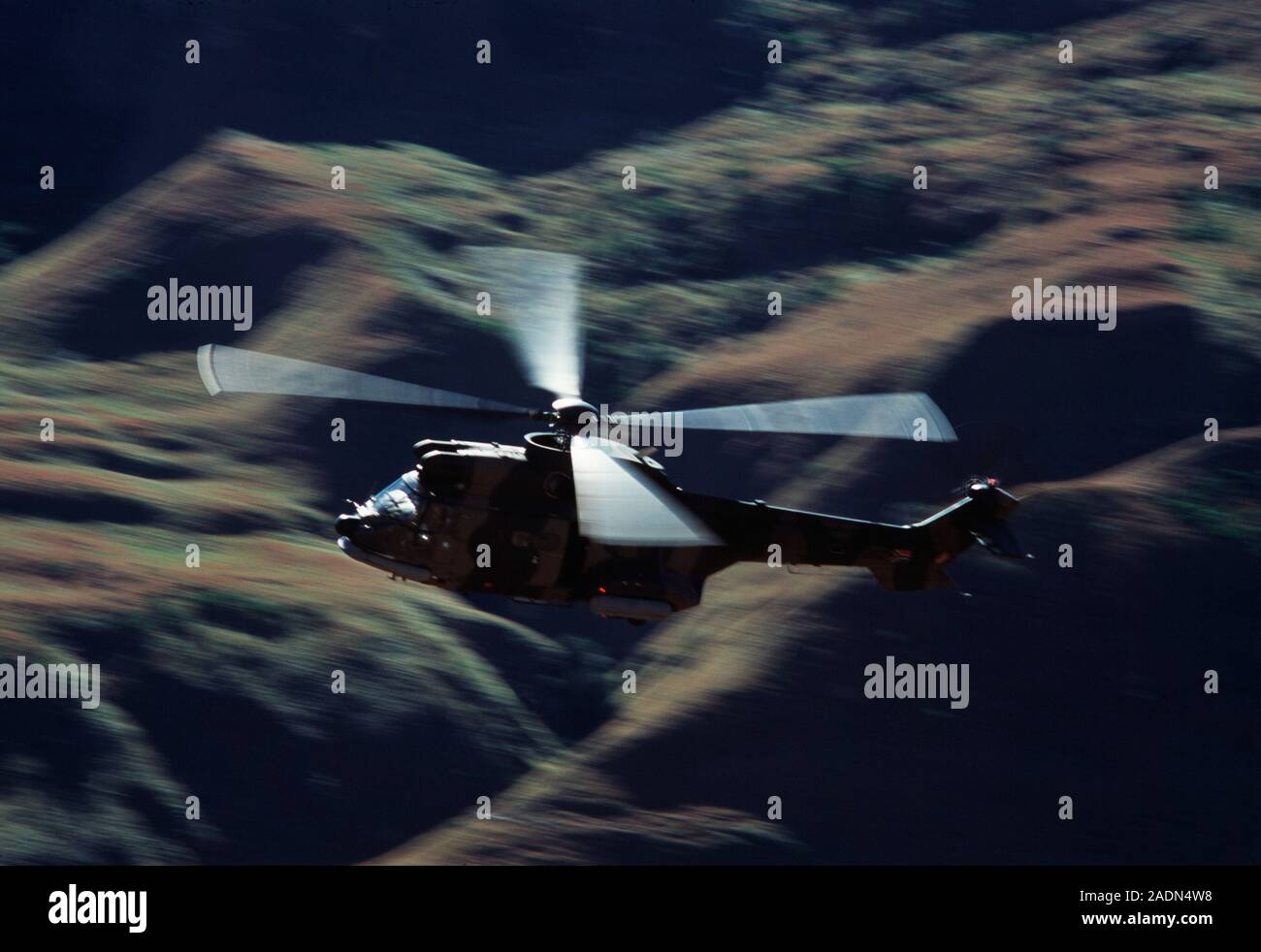 Oryx helicopter flying over mountainous terrain. The Oryx is a medium ...