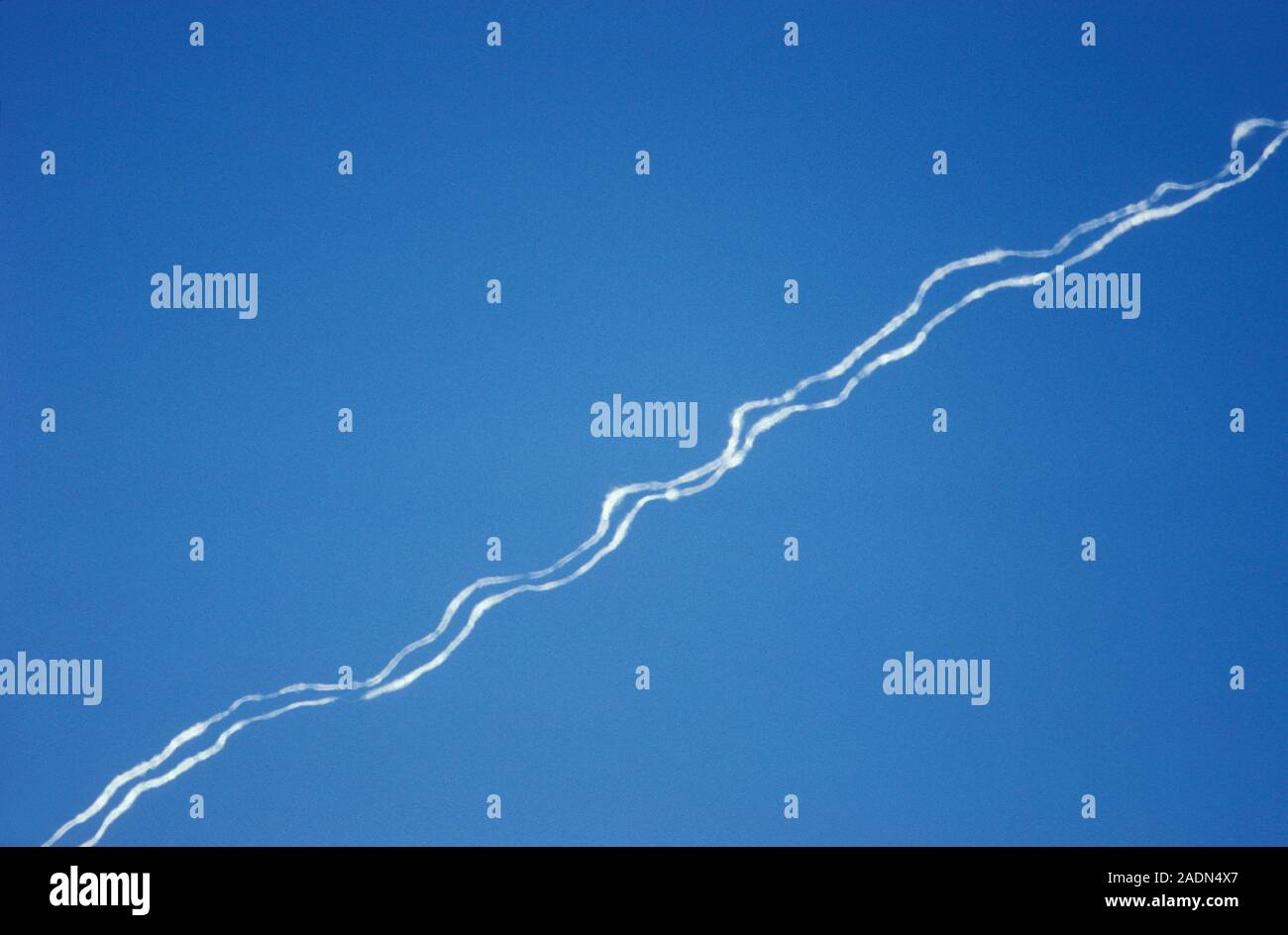 Aircraft contrail, or vapour trail, left by an aircraft flying at high ...