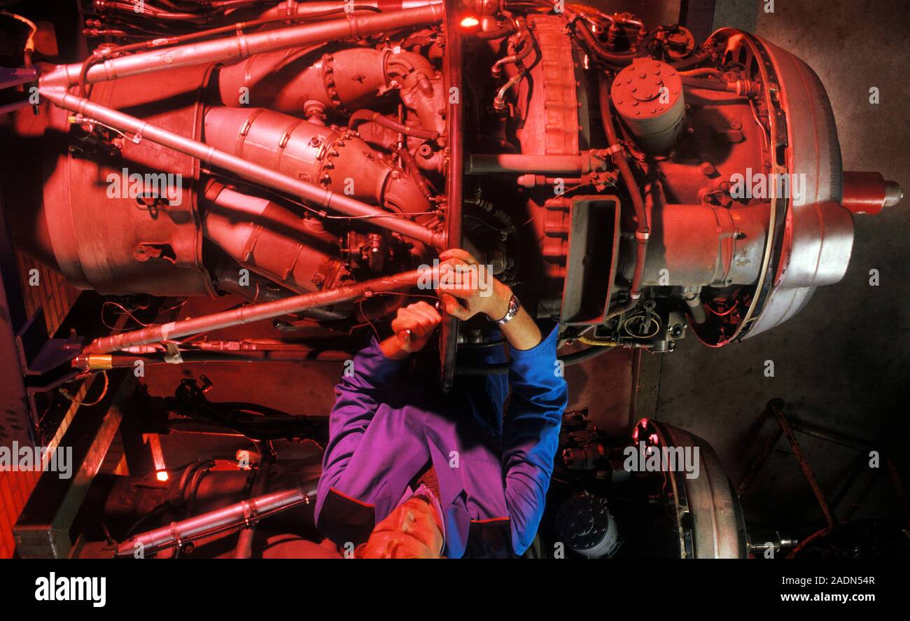 Aeroplane engine maintenance. Engineer working on an aeroplane engine ...
