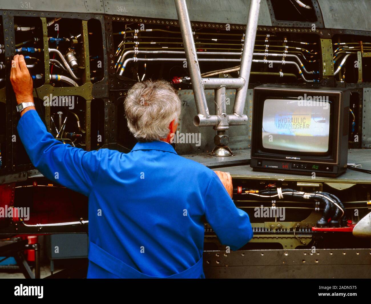 Aircraft testing. Technician visually checking the internal structure ...