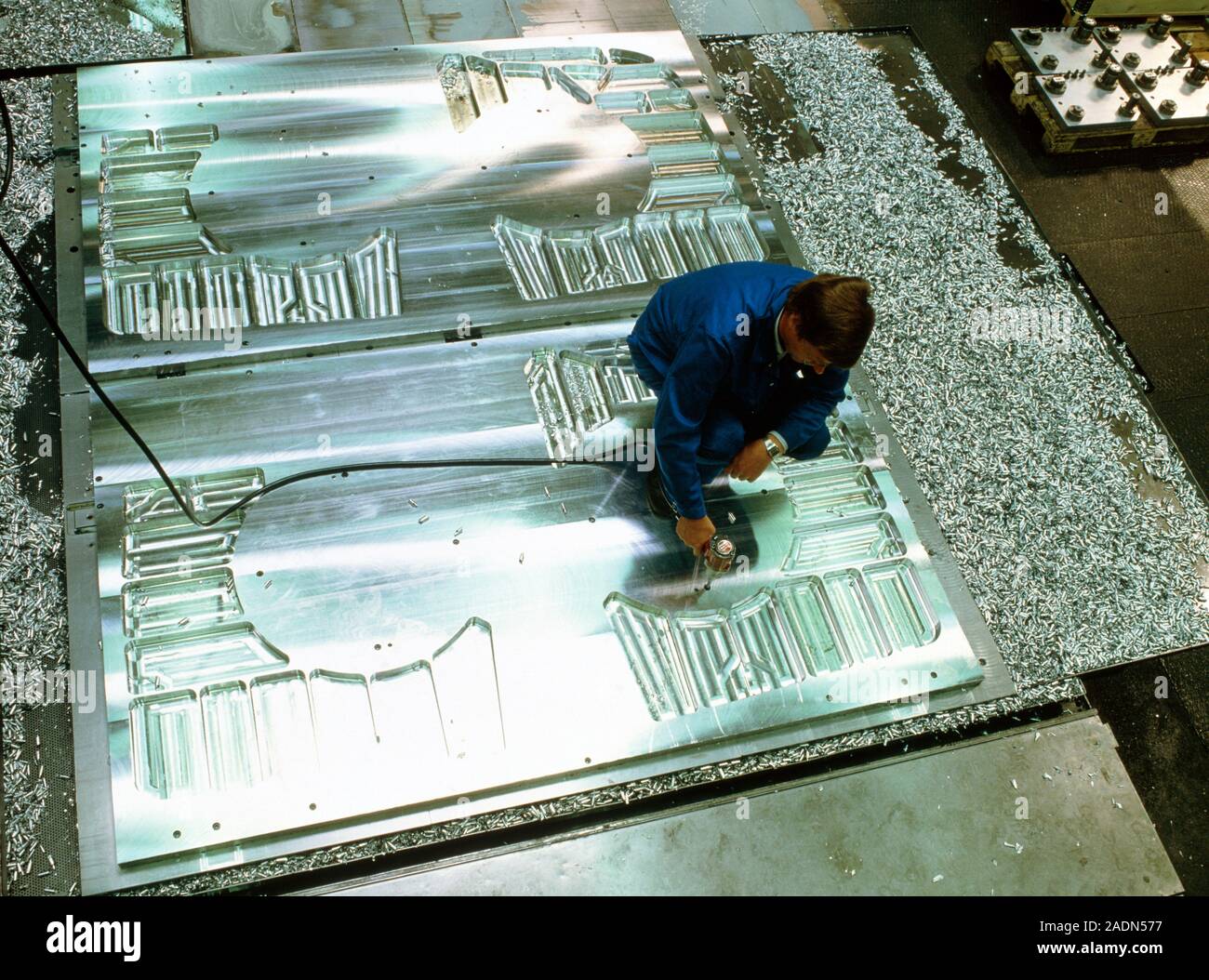 Aircraft construction. Technician drilling into an aluminium component ...