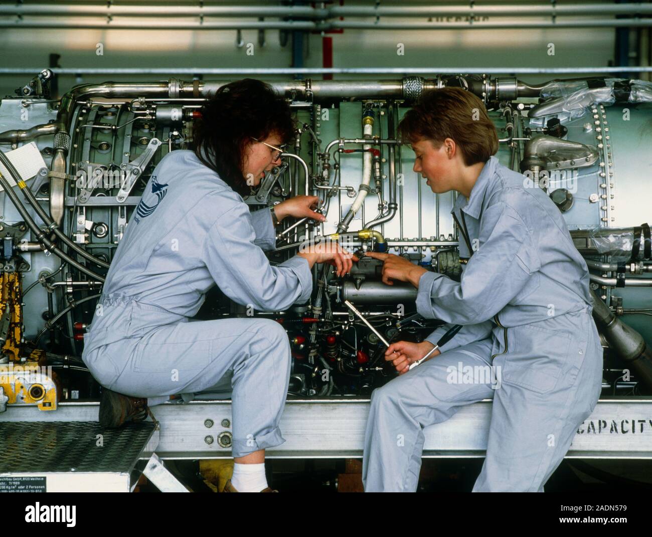 Aircraft engine. Two female engineers constructing a jet engine for use ...