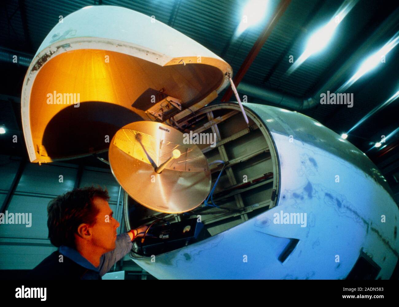 Aircraft maintenance. View of a technician checking the nose-mounted ...