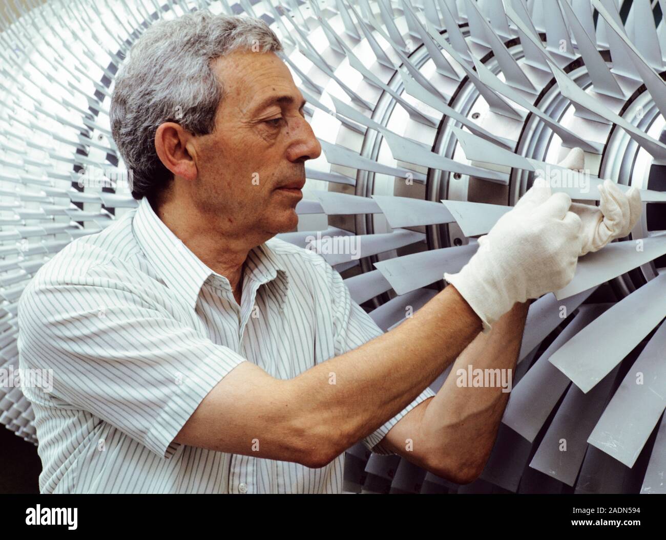 Aerospace mechanic assembling the blades of a compressor rotor for an ...