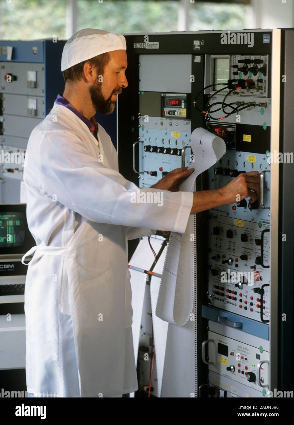 MODEL RELEASED. Aviation test. Technician reading the data from an ...