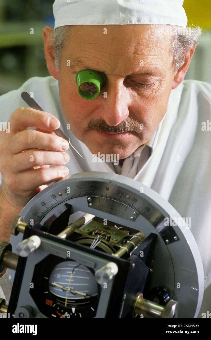 MODEL RELEASED. Gyroscope assembly. Mechanic assembling a gyroscope for ...