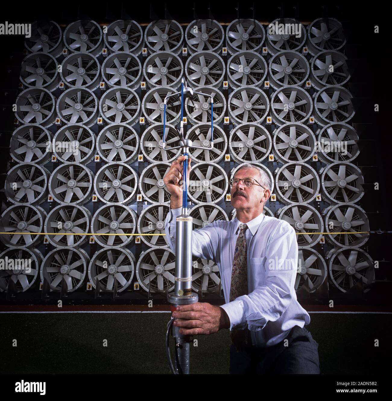 Aerospace research. Researcher preparing an anemometer for use in a ...