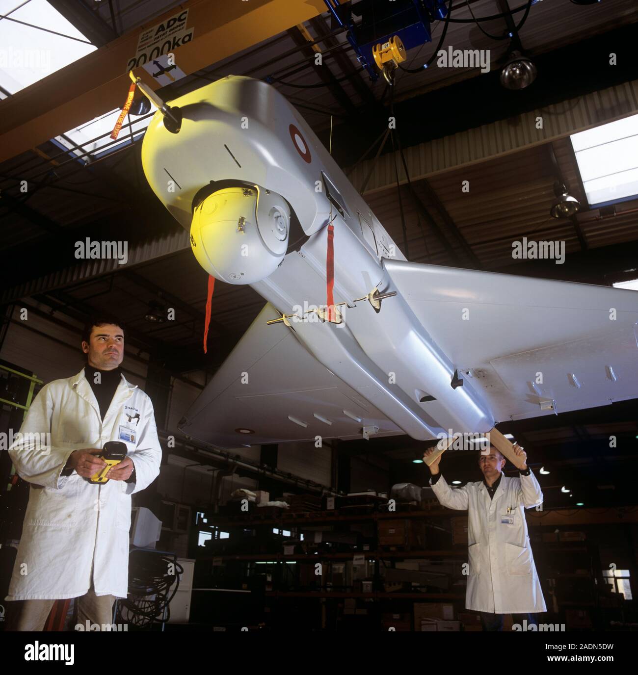 Sperwer UAV manufacture. Engineers using an electric hoist system to ...