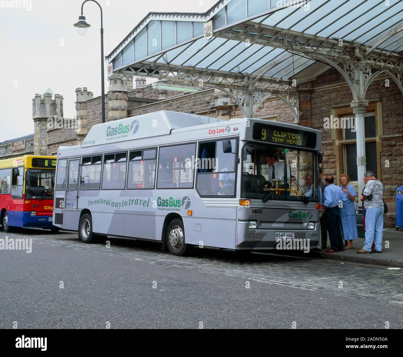 Gas-powered bus. Passengers boarding a bus which uses natural gas ...