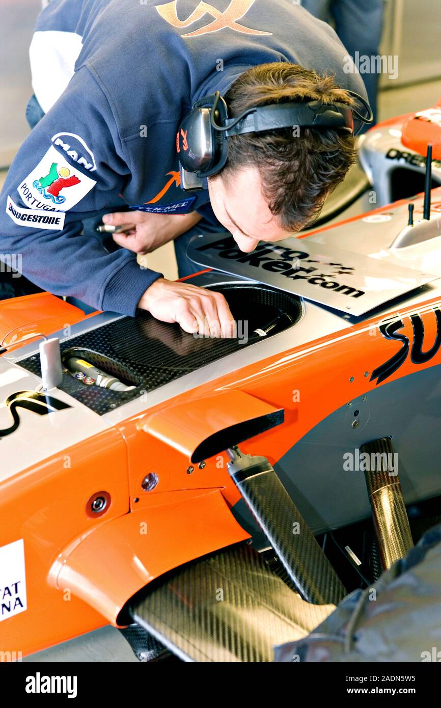 MODEL RELEASED. Formula One car preparation. Mechanic checking the ...