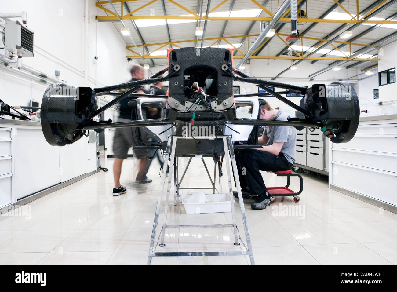 MODEL RELEASED. Formula One car construction. Mechanics fitting a ...