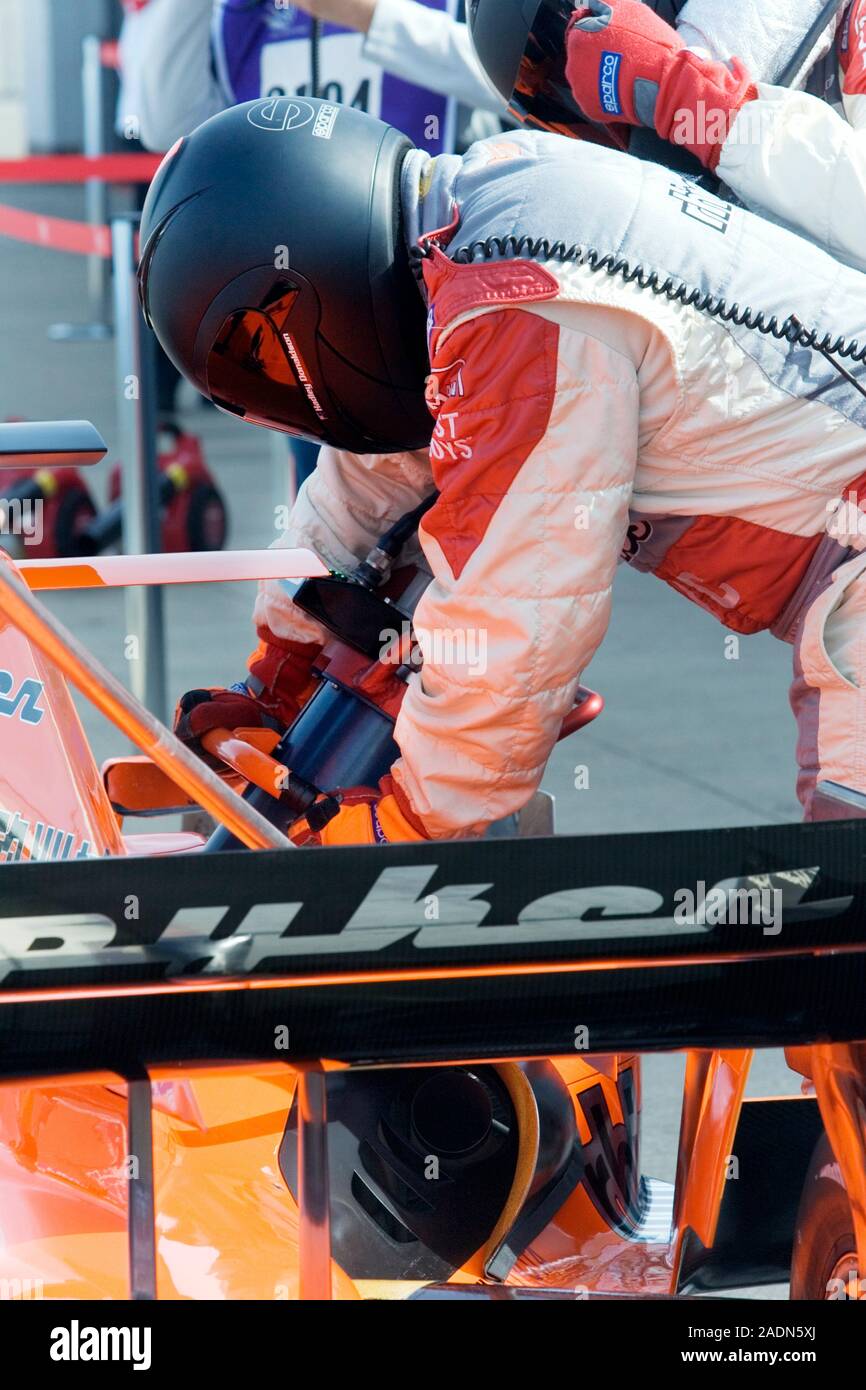 MODEL RELEASED. Formula One racing. ÂPit crew refuelling a racing car ...