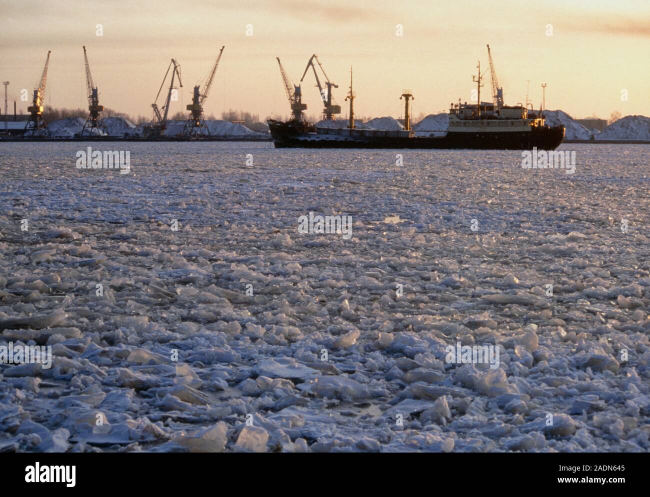 Ship. Anchored cargo ship on the frozen River Lena. The cranes on the ...